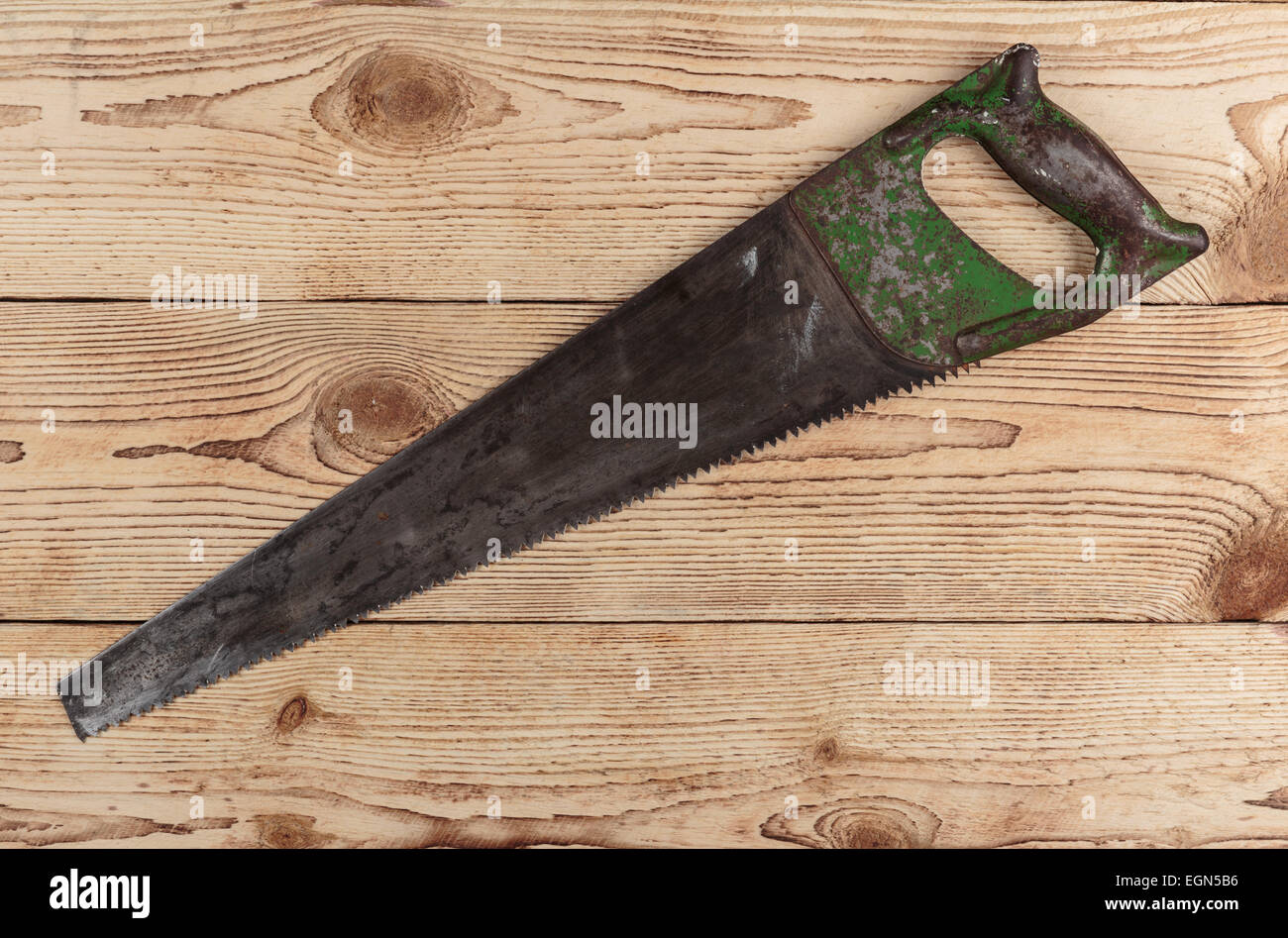 old saw on wooden background Stock Photo - Alamy