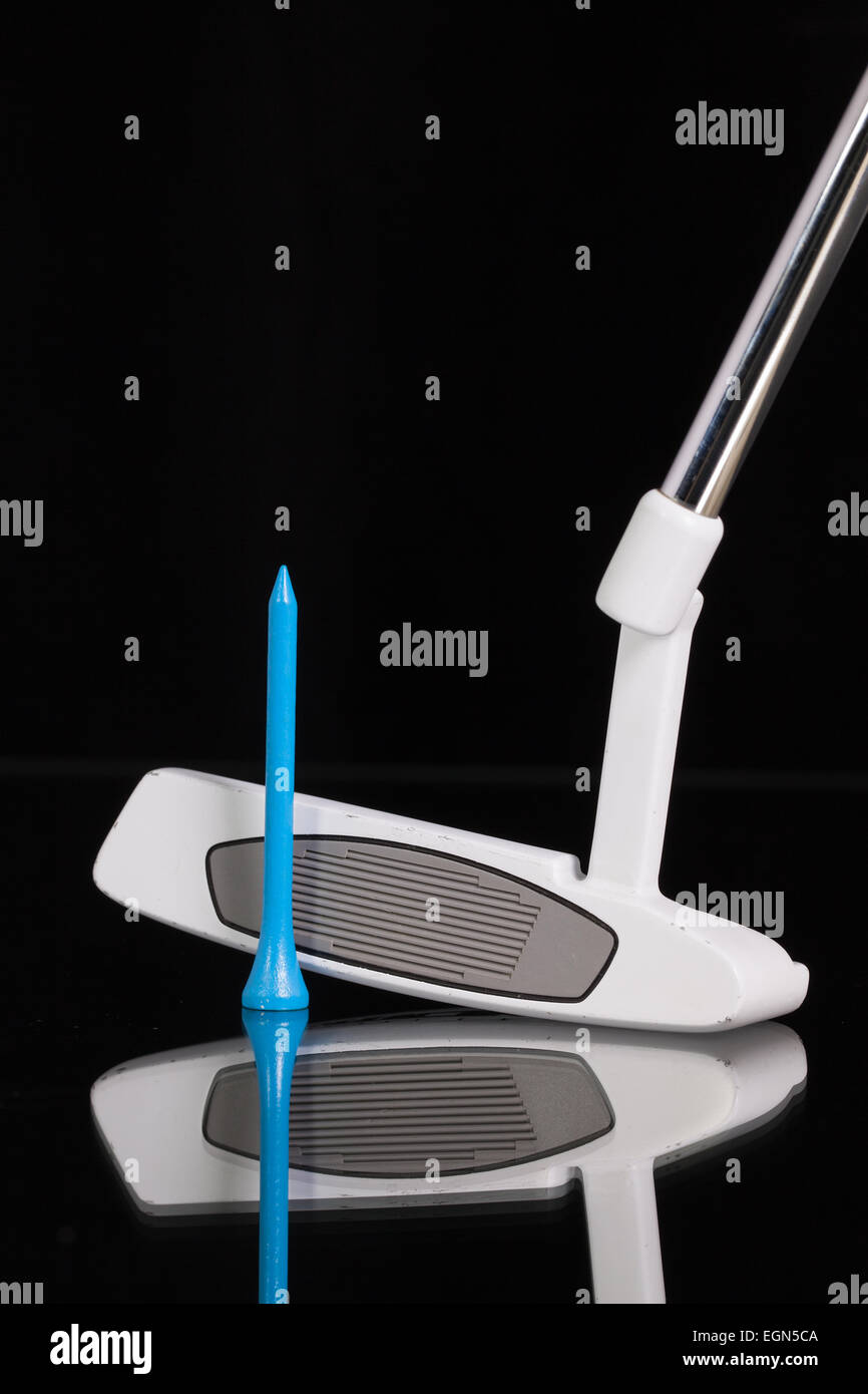 Golf putter and different golf equipments on the black glass desk Stock ...