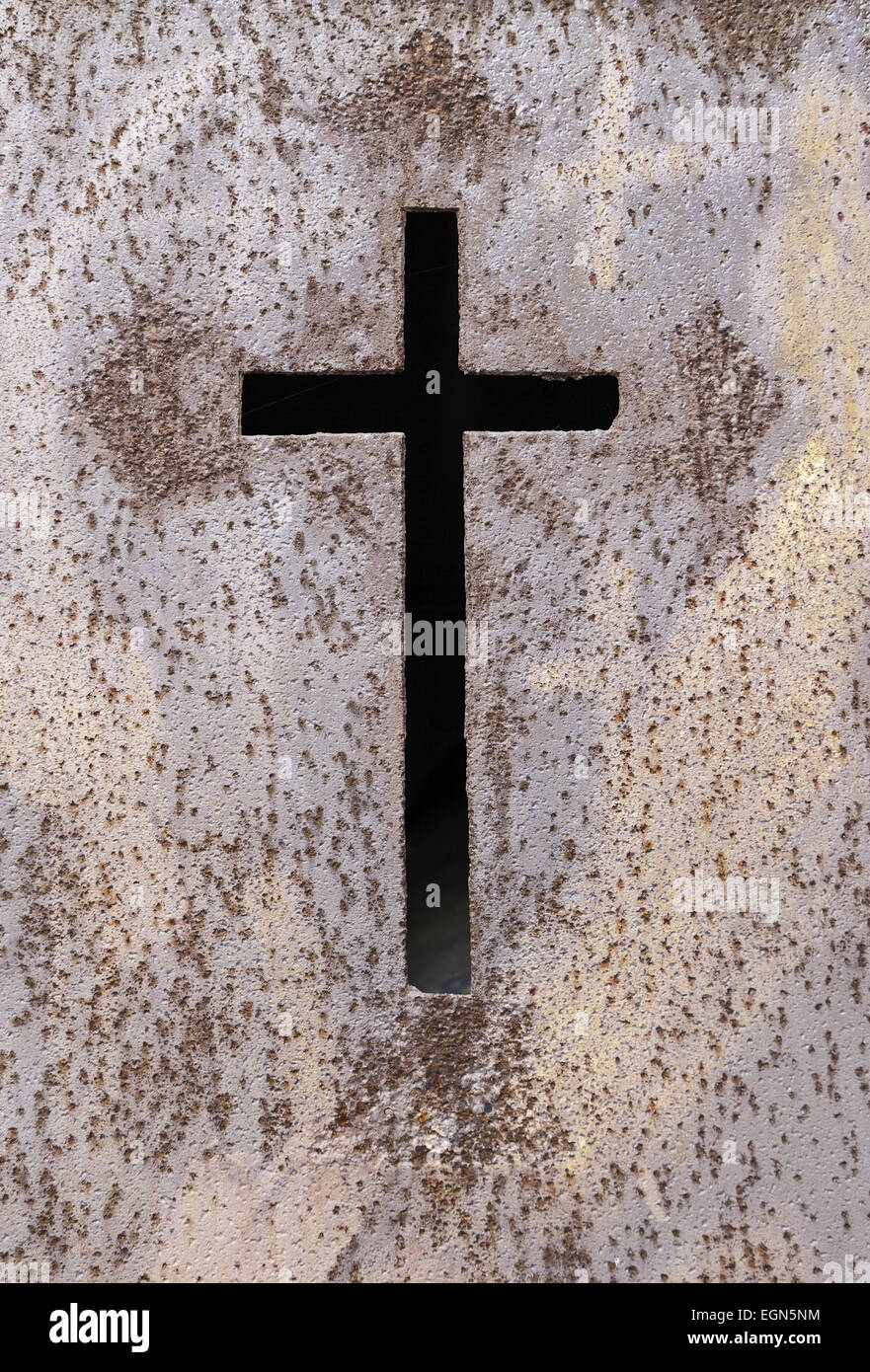 Old rusty metal cross, detail of an old cross on a metal wall, cemetery ...