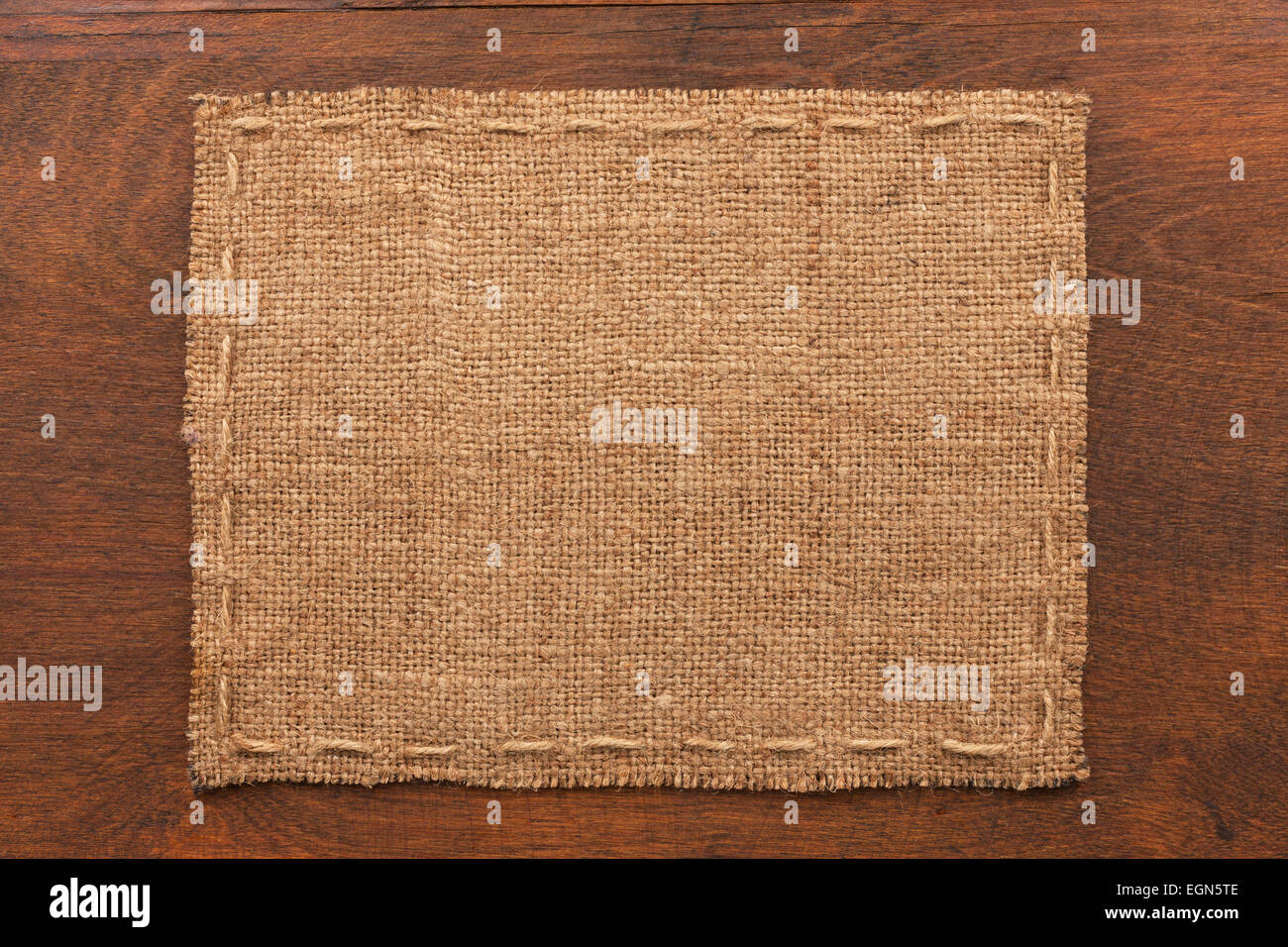 Frame of burlap, lies on a background of wood, with place for your text ...