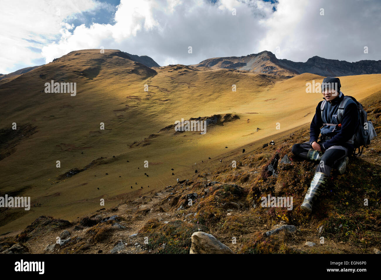 BHUTAN - Assistant guide, Gyembo, waiting while the trekking group ...