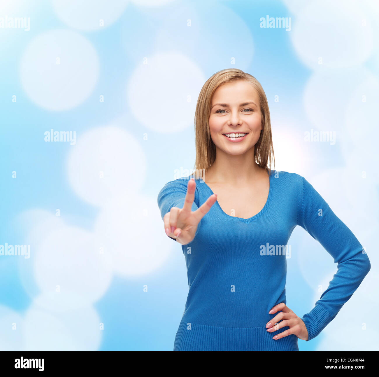 smiling teenage girl showing v-sign with hand Stock Photo - Alamy