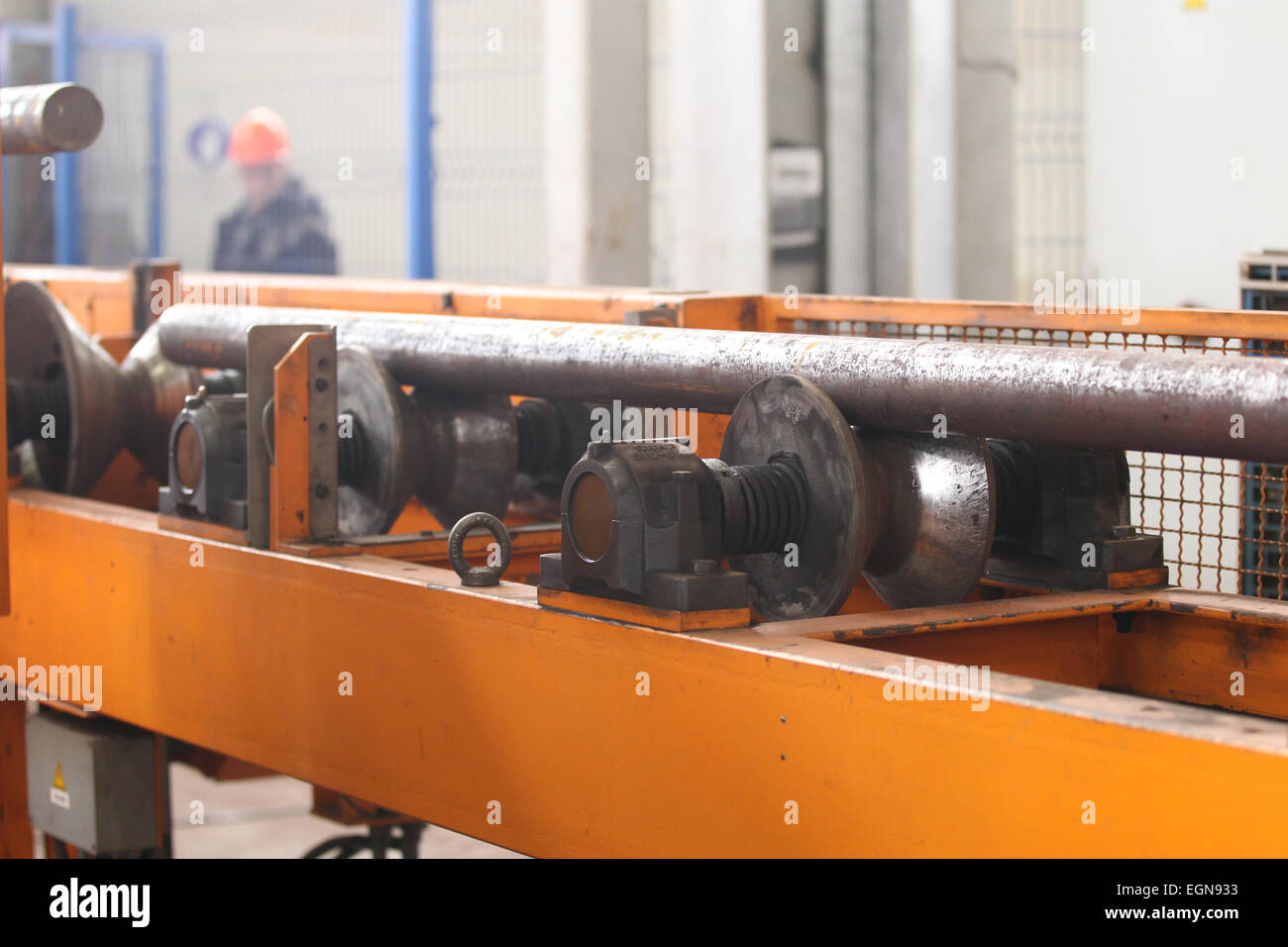 movement of a long metal rod through the rollers Stock Photo - Alamy