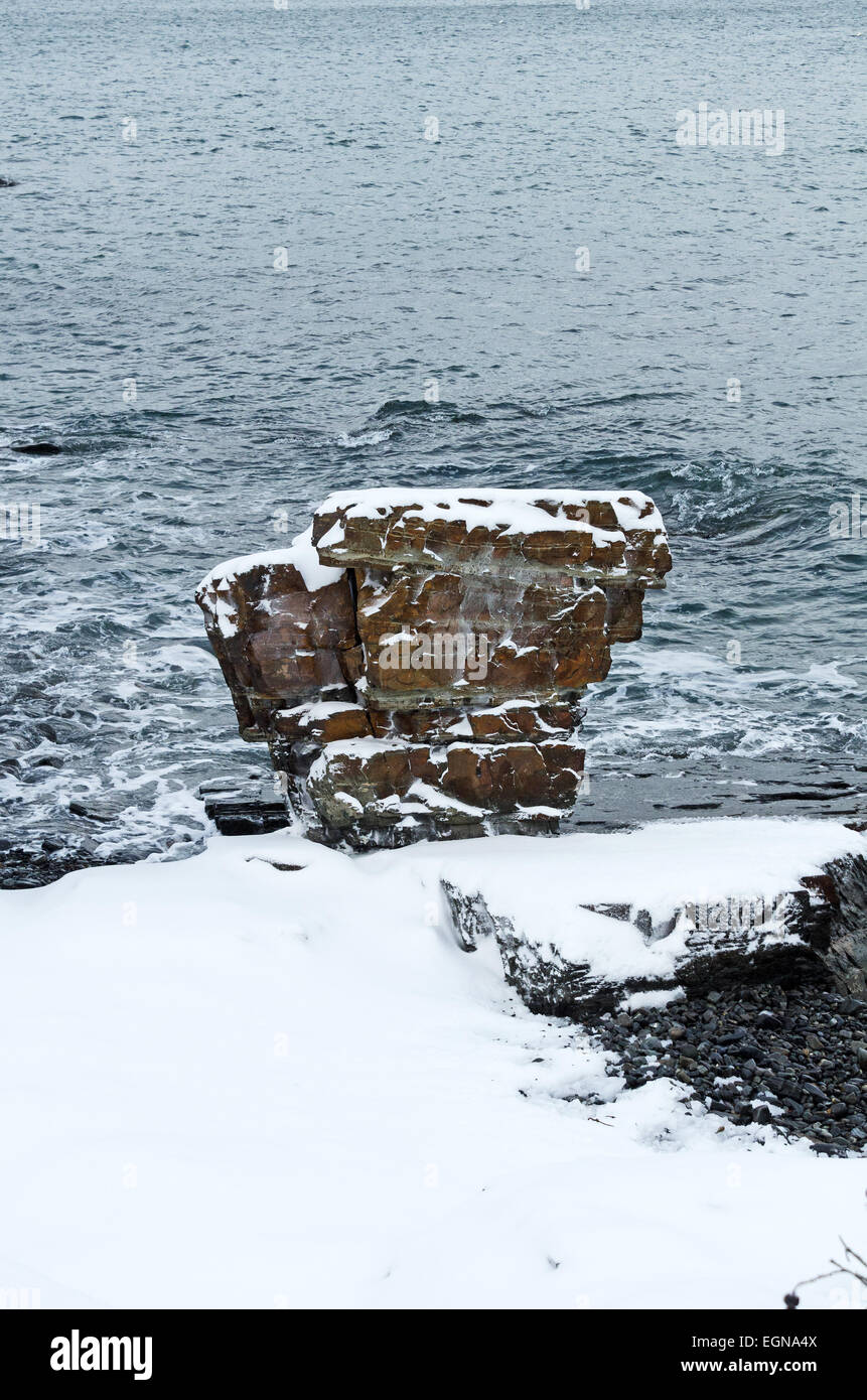 Pulpit Rock, a snow-covered sea stack off the Shore Path in Bar Harbor ...