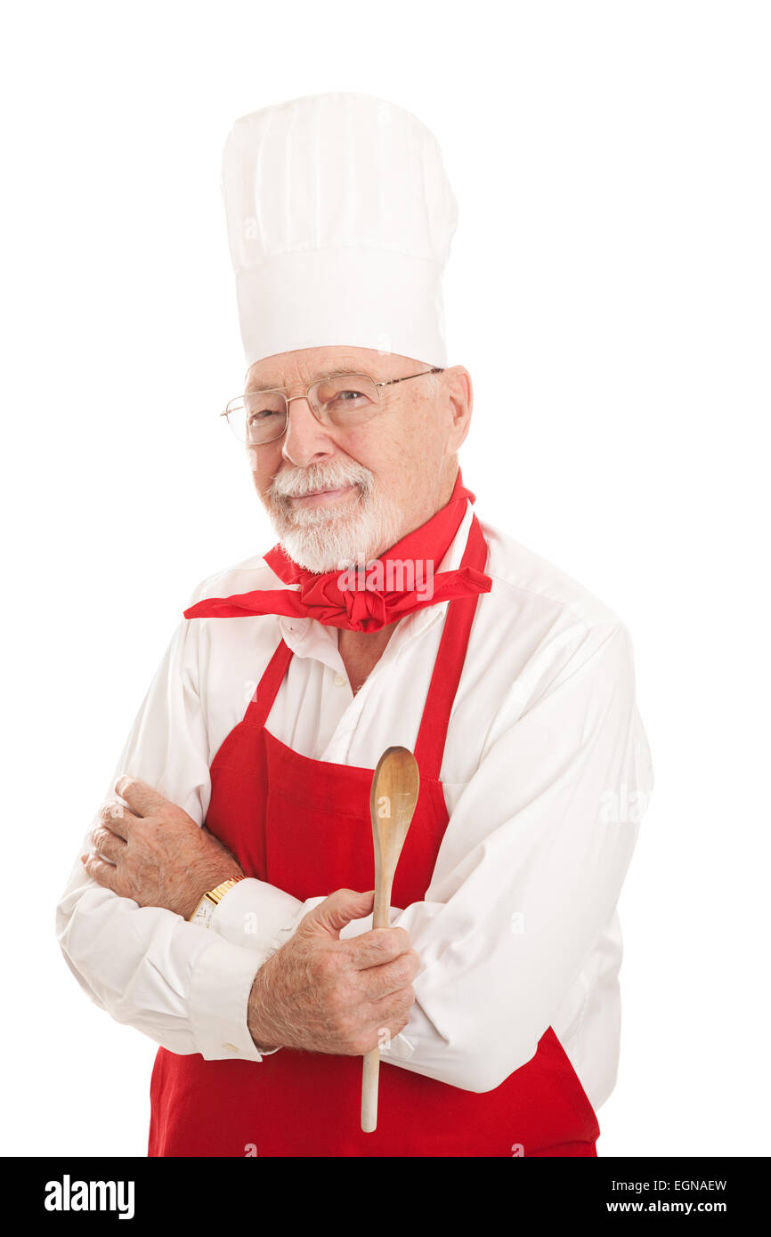 Experienced older chef holding a wooden spoon. Serious expression ...