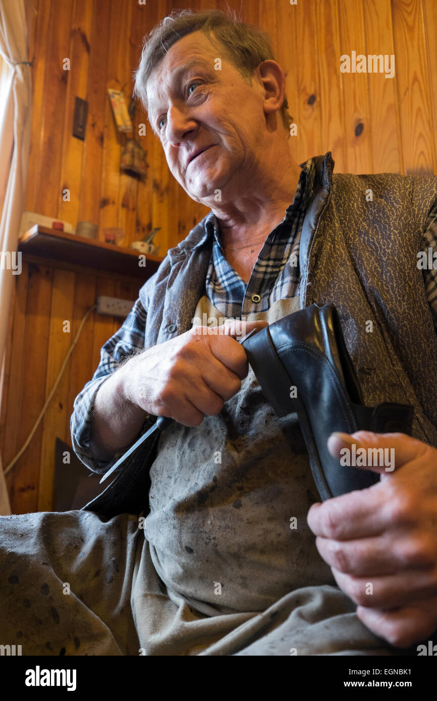 Cobbler mending shoe hi-res stock photography and images - Alamy