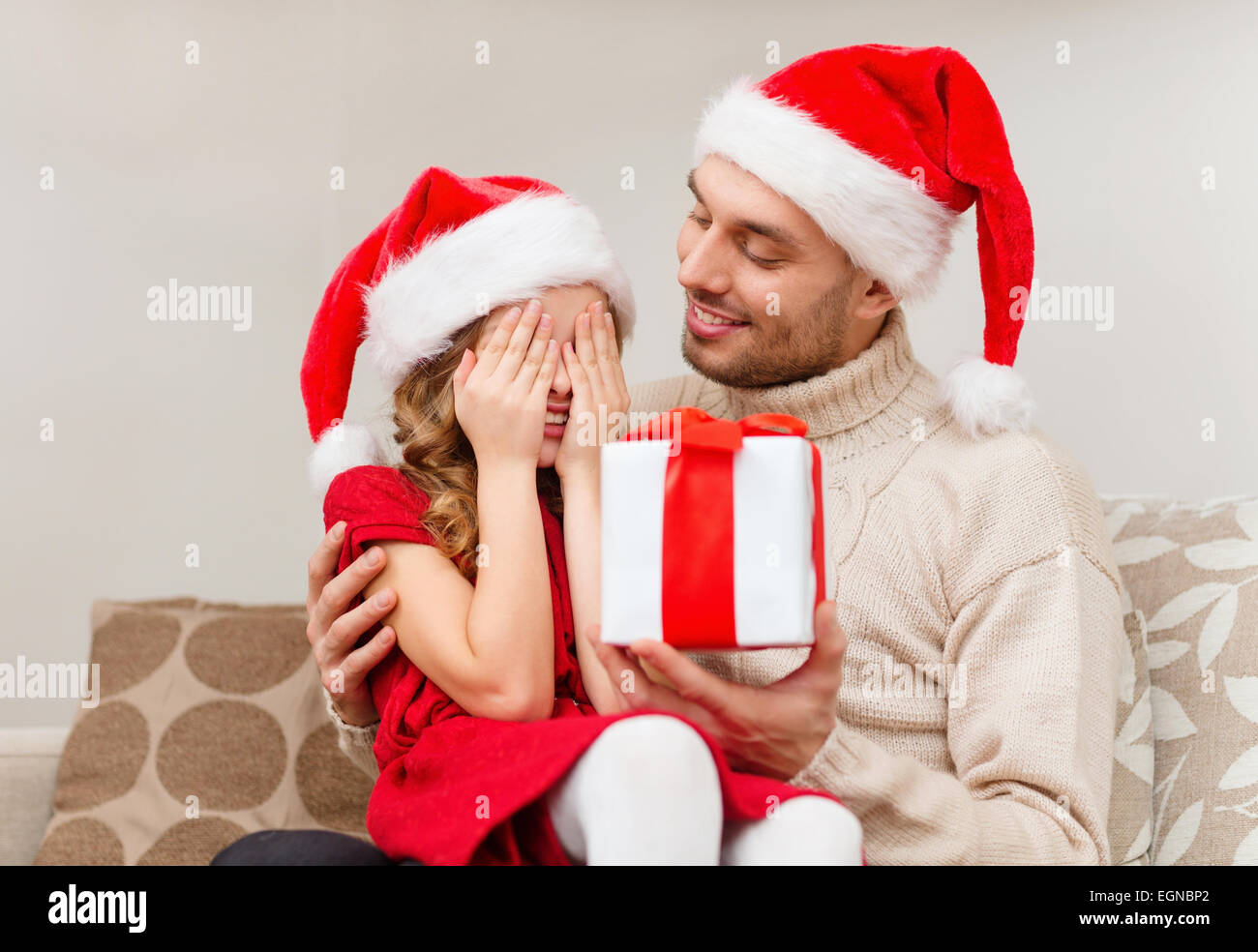 smiling daughter waiting for a present from father Stock Photo - Alamy