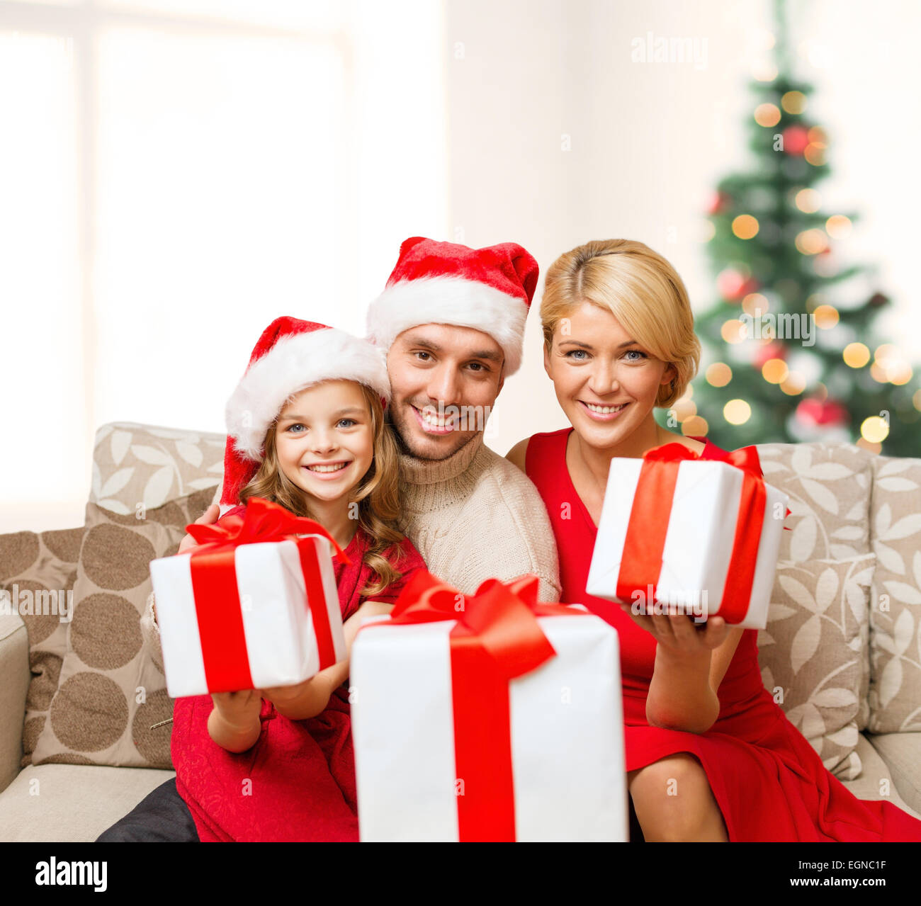 smiling family giving many gift boxes Stock Photo - Alamy