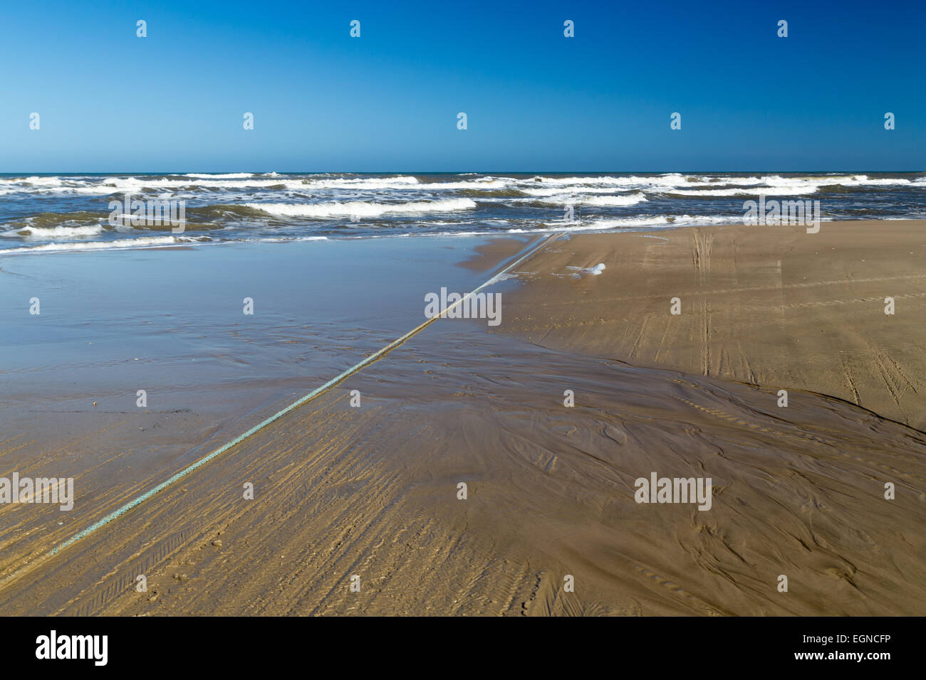 Wire going into sea and sand texture Stock Photo - Alamy