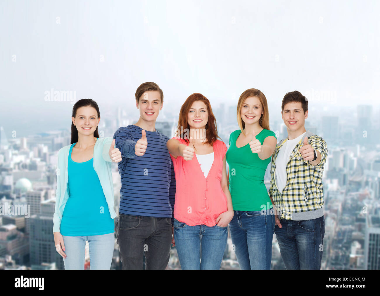 group of smiling students showing thumbs up Stock Photo - Alamy