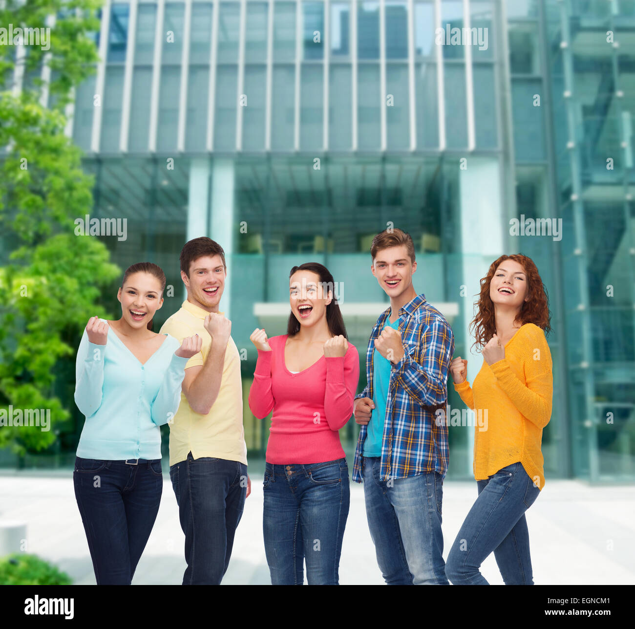 group of smiling teenagers showing triumph gesture Stock Photo - Alamy