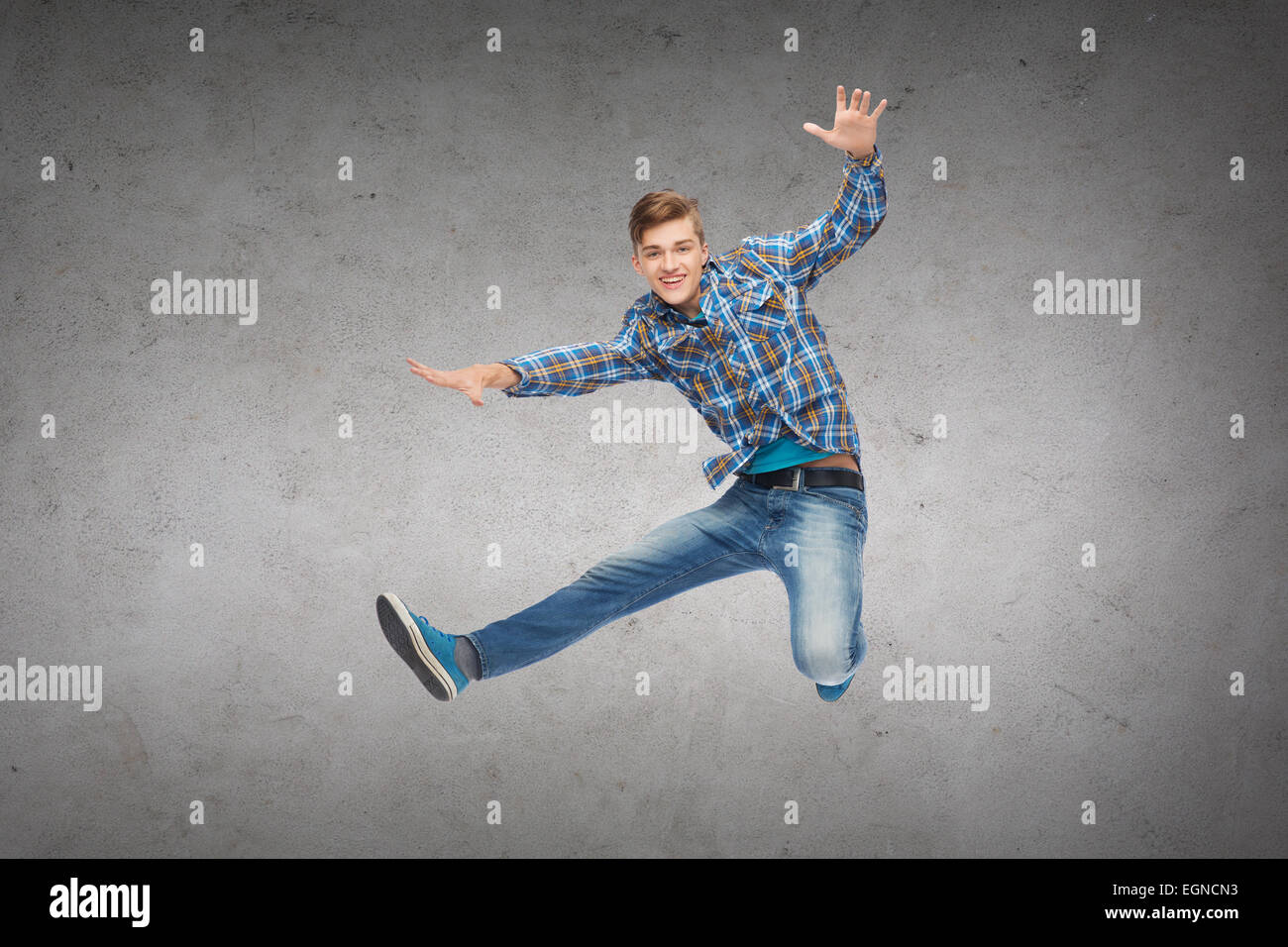 smiling young man jumping in air Stock Photo - Alamy