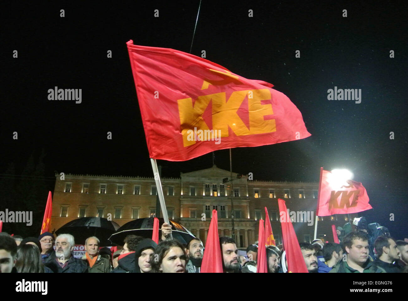 Athens, Greece. 27th February, 2015. A demonstrator waves a red flag of ...