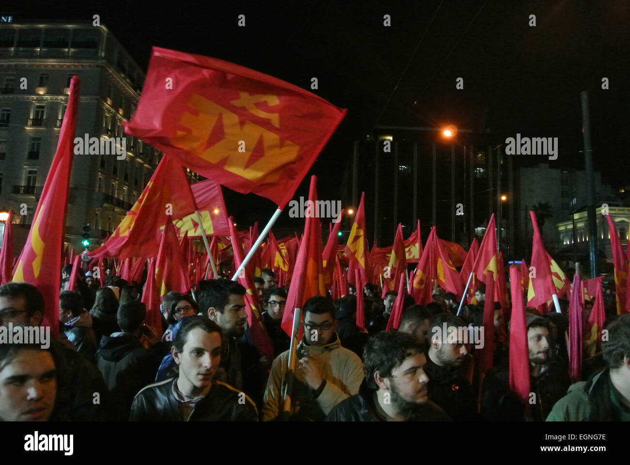 Athens, Greece. 27th February, 2015. KKE suporters hold red flags with ...