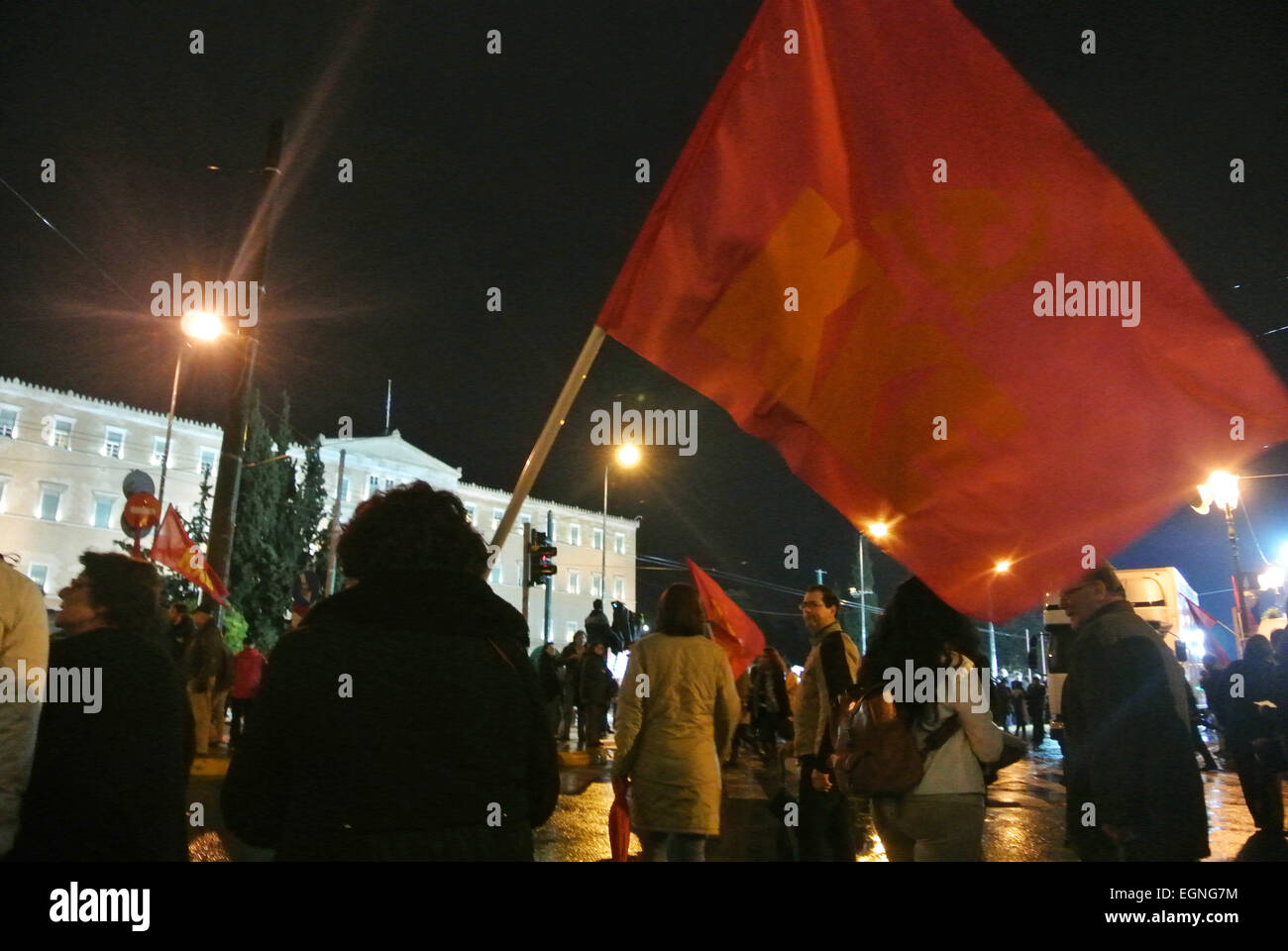 Athens, Greece. 27th February, 2015. A KKE supporter waves a red flag ...