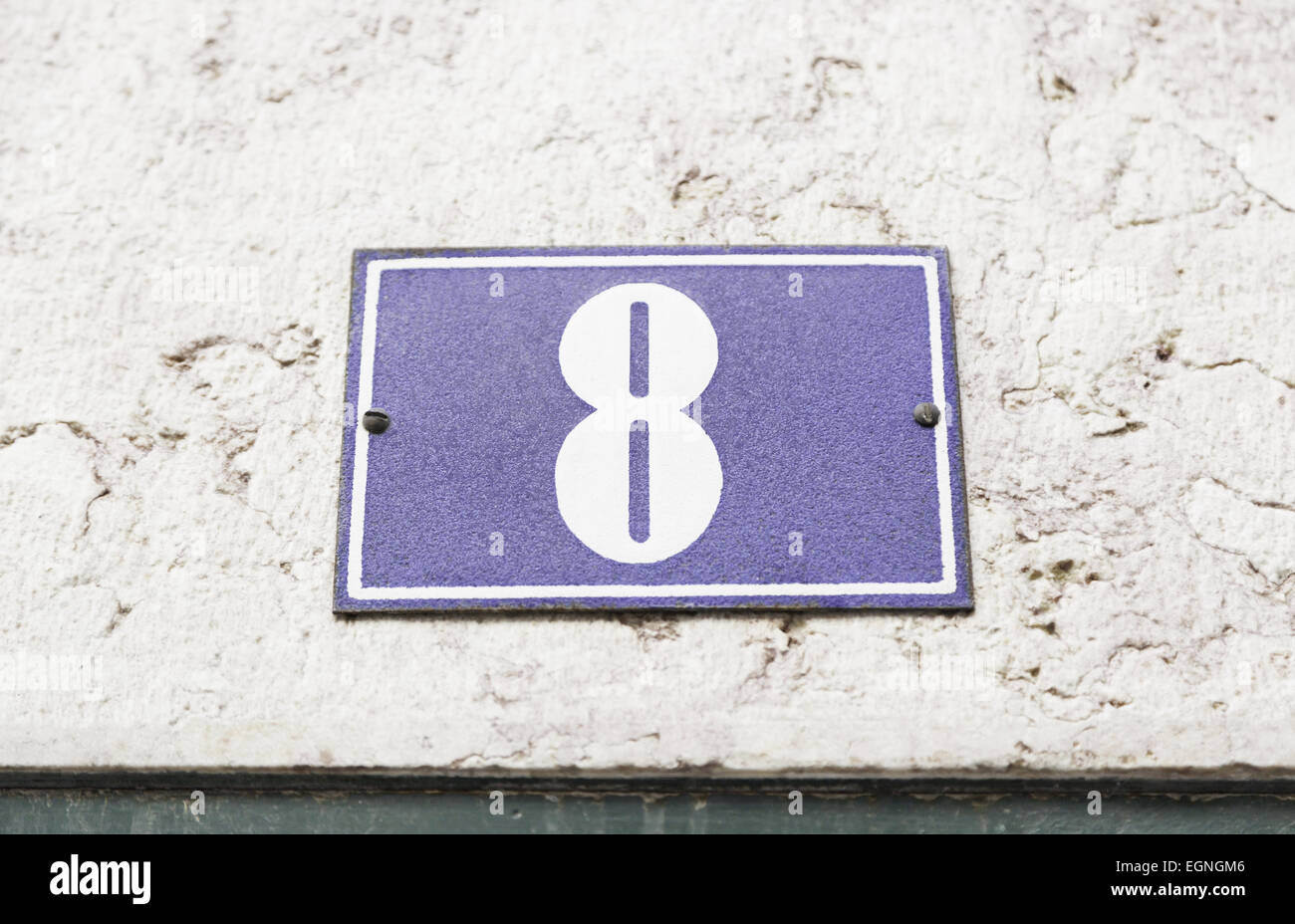 Number eight on a wall, detail of a number Stock Photo - Alamy