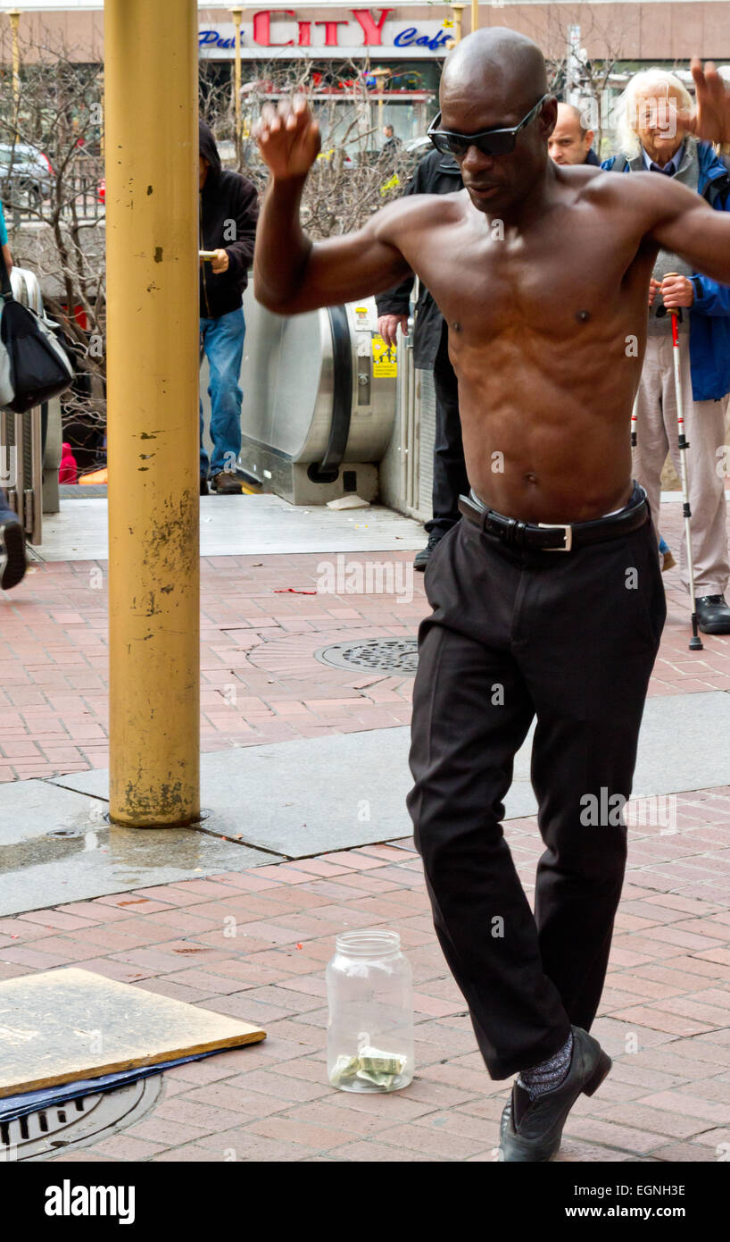 An athletic black man street dancing with a jar for donations Stock ...