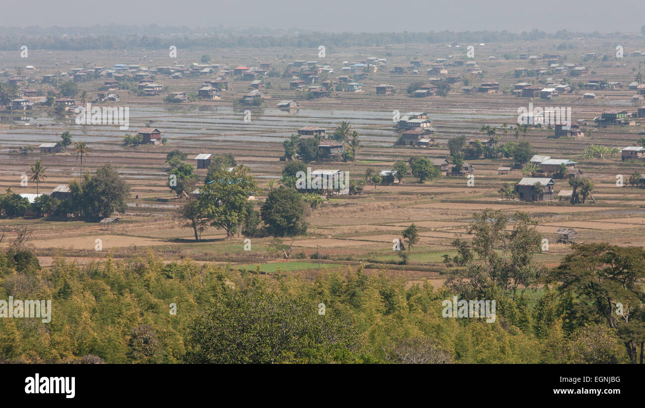 Aerial view of banks of Inle Lake and lots of houses on stilts above ...