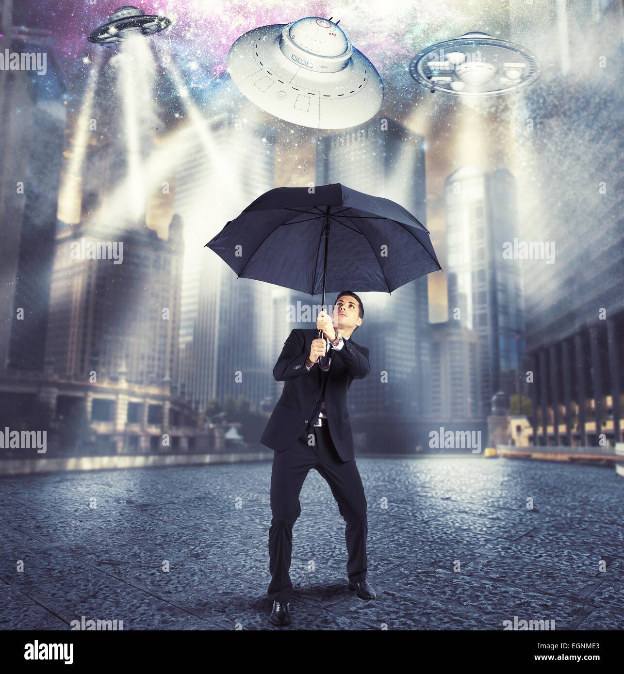 Businessman against alien attack Stock Photo - Alamy