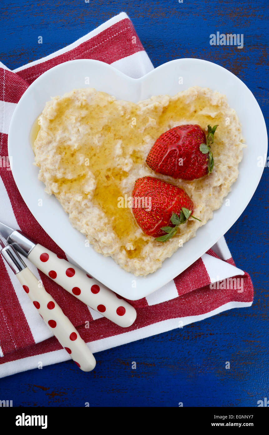 Plate of nutritious and healthy cooked breakfast oats with strawberries ...