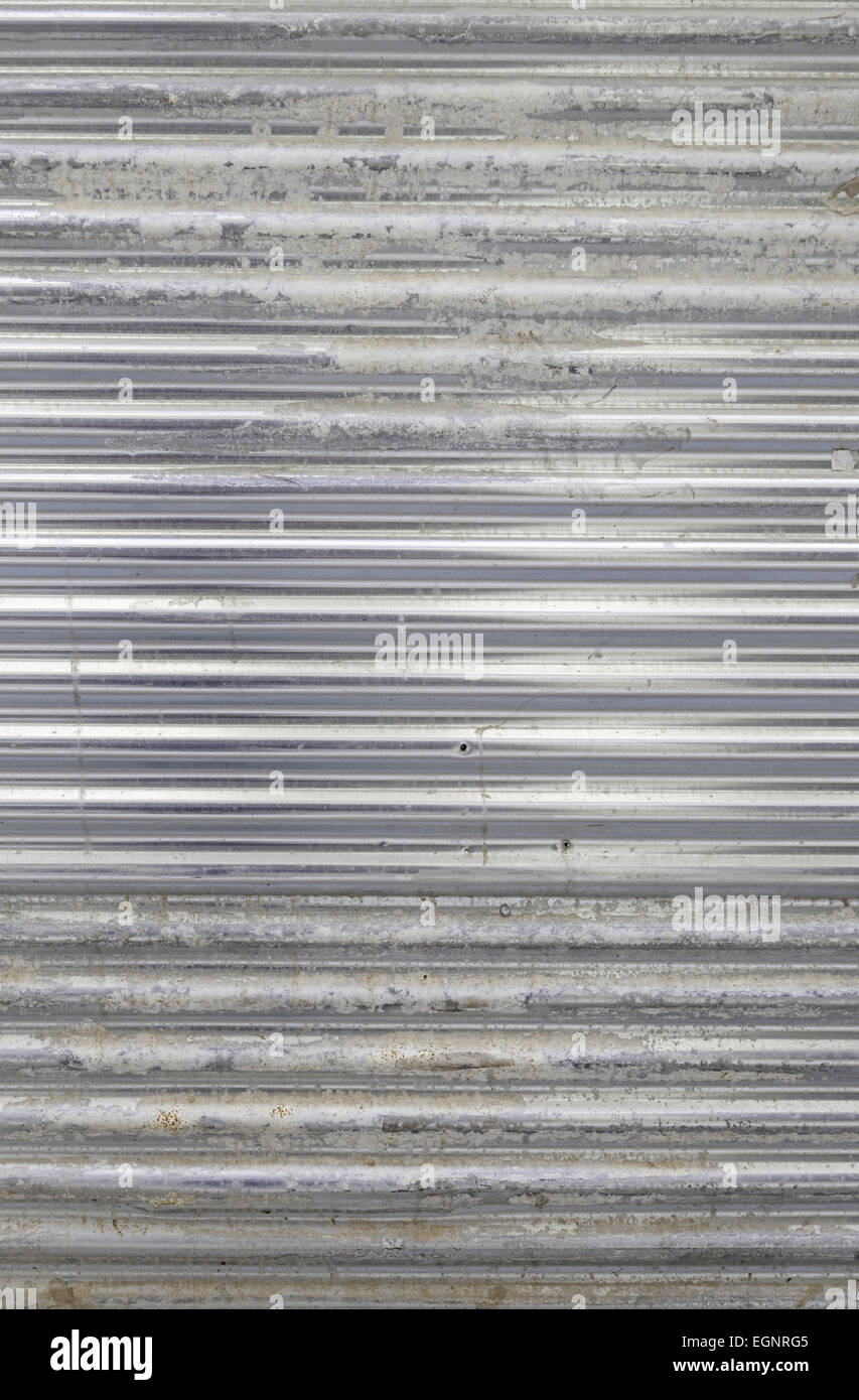Dirty and damaged metal wall, detail of a metallic textured background ...