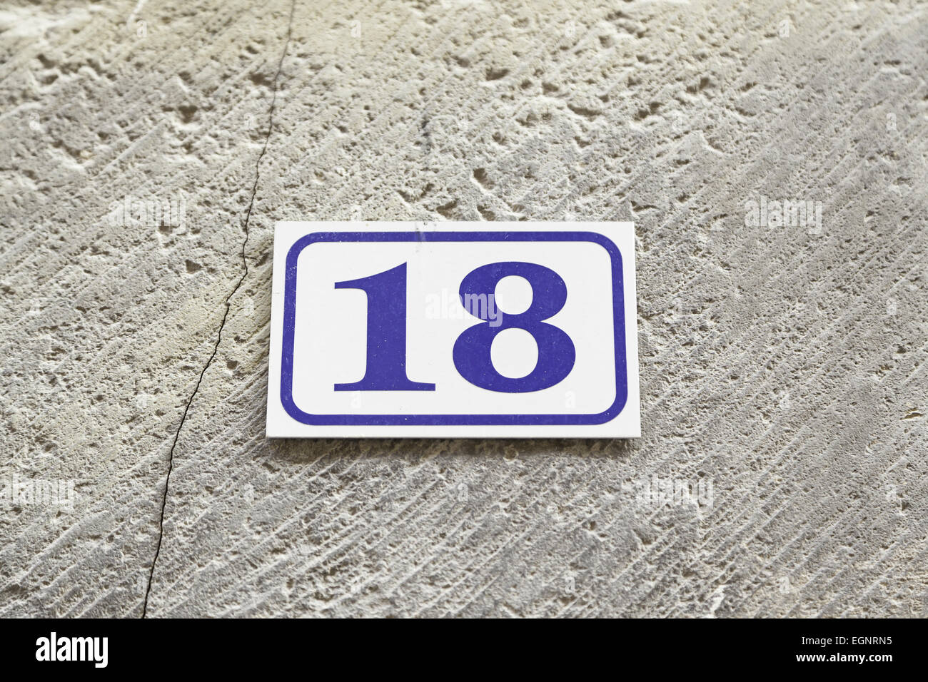 Number eighteen on a wall, detail of a number of information on a wall ...