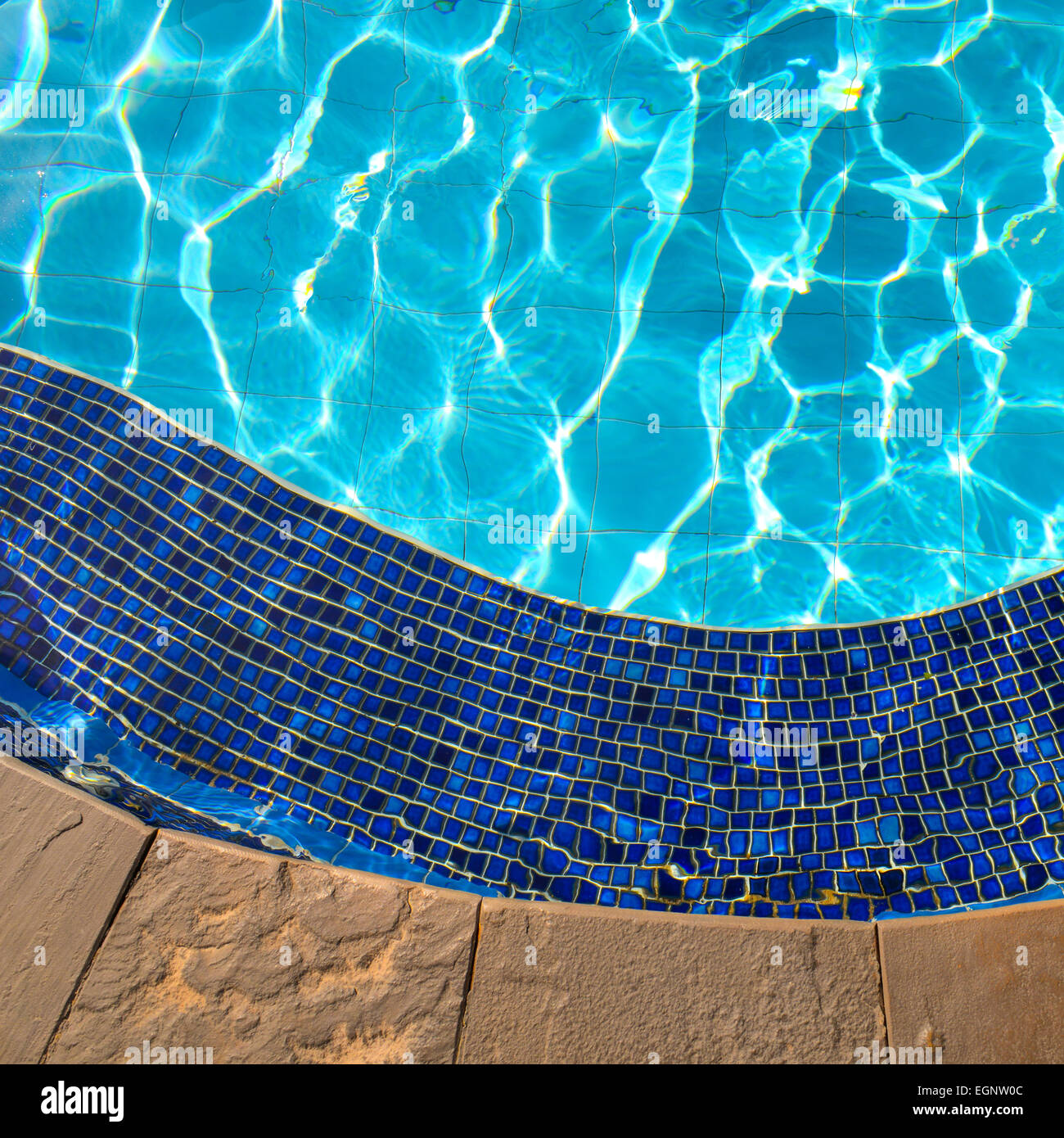 Blue tiles of jacuzzi in the Swimming pool blue water and sunlight ...