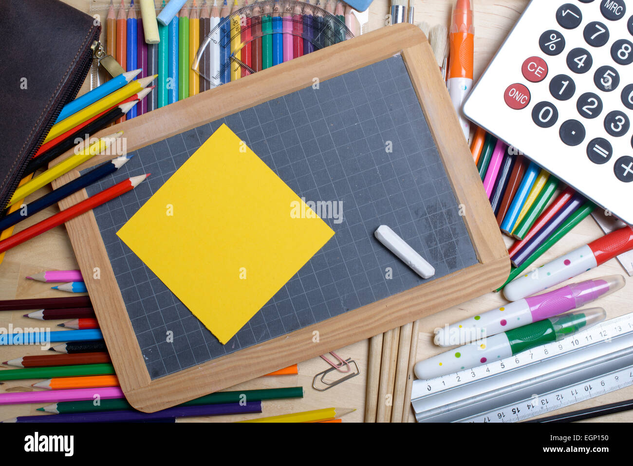 school supplies with a blackboard and yellow paper Stock Photo - Alamy