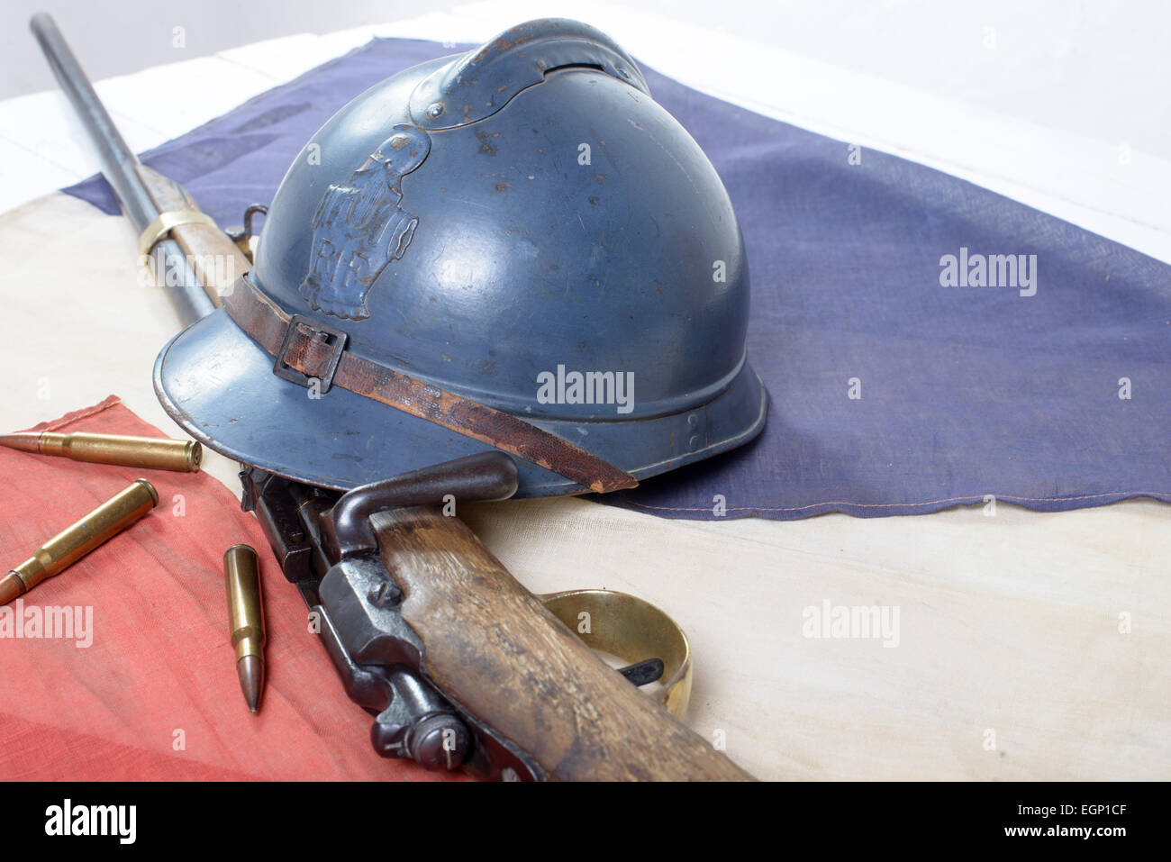 french military helmet of the First World War with a gun on a blue ...
