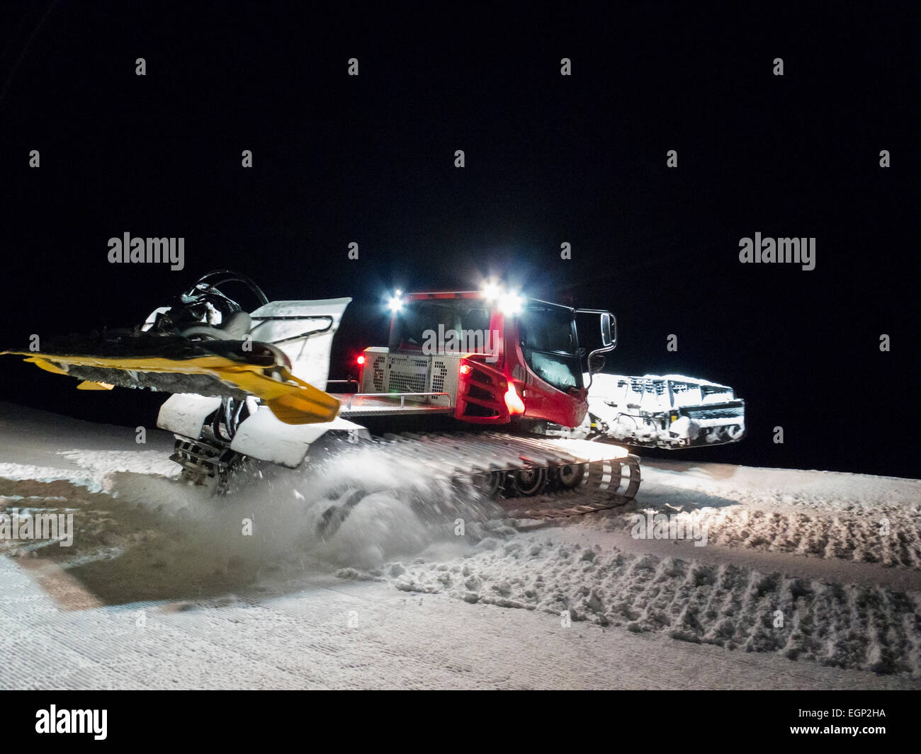 PistenBully piste basher working at night in La Clusaz Stock Photo - Alamy
