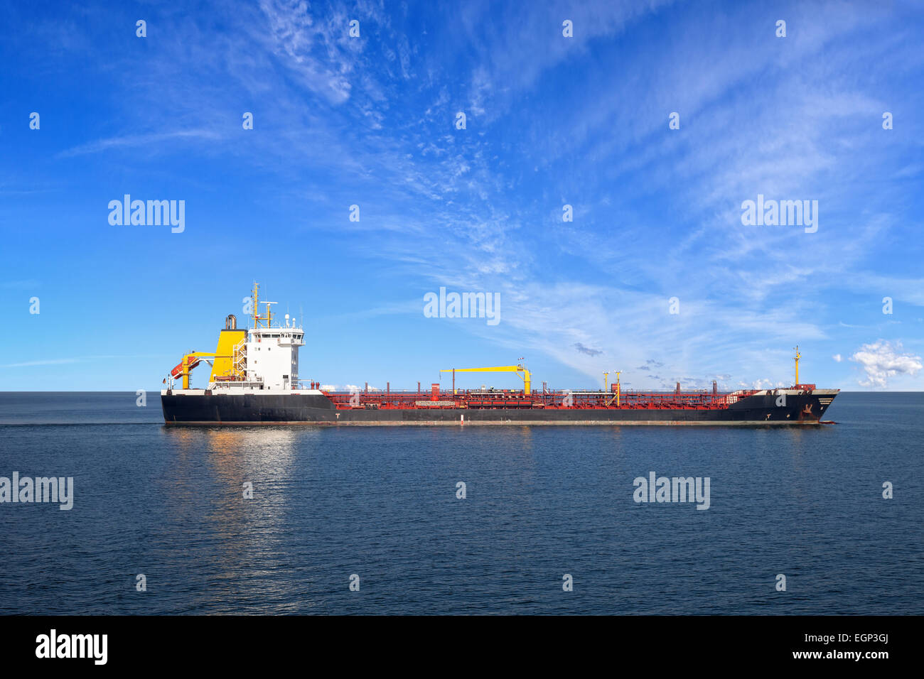 Oil tanker ship at sea on a background of blue sky Stock Photo - Alamy