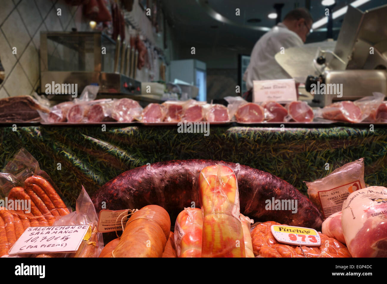 Butcher cutting meat, window display with sausages, pork meat, Beef ...