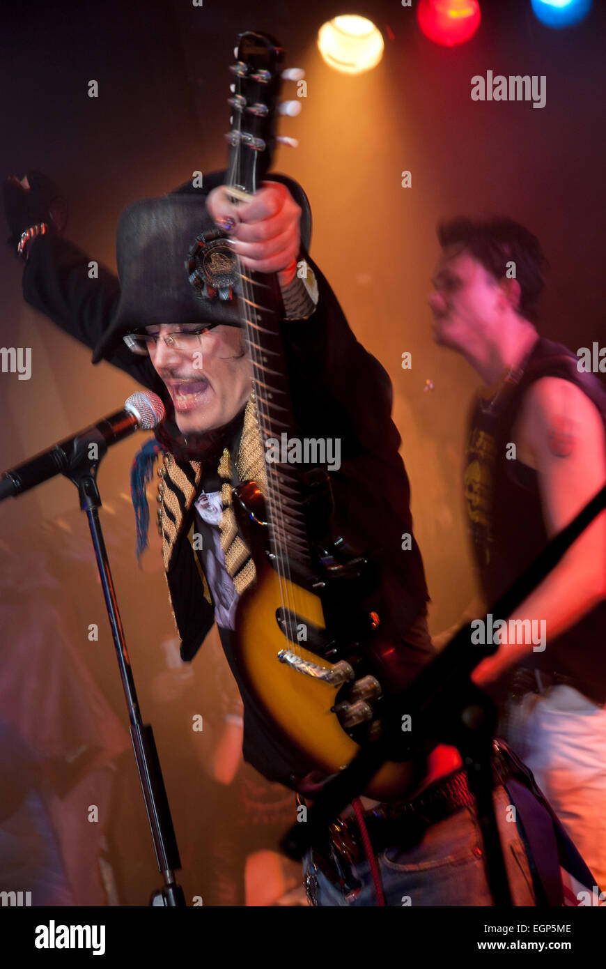 Adam Ant holding guitar out live on stage Stock Photo - Alamy
