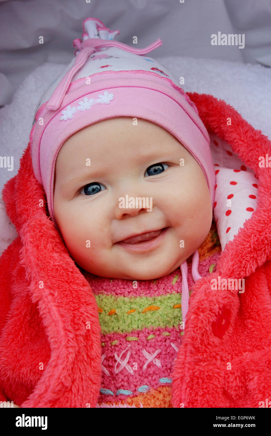 little baby in red suit is smiling in the perambulator Stock Photo - Alamy