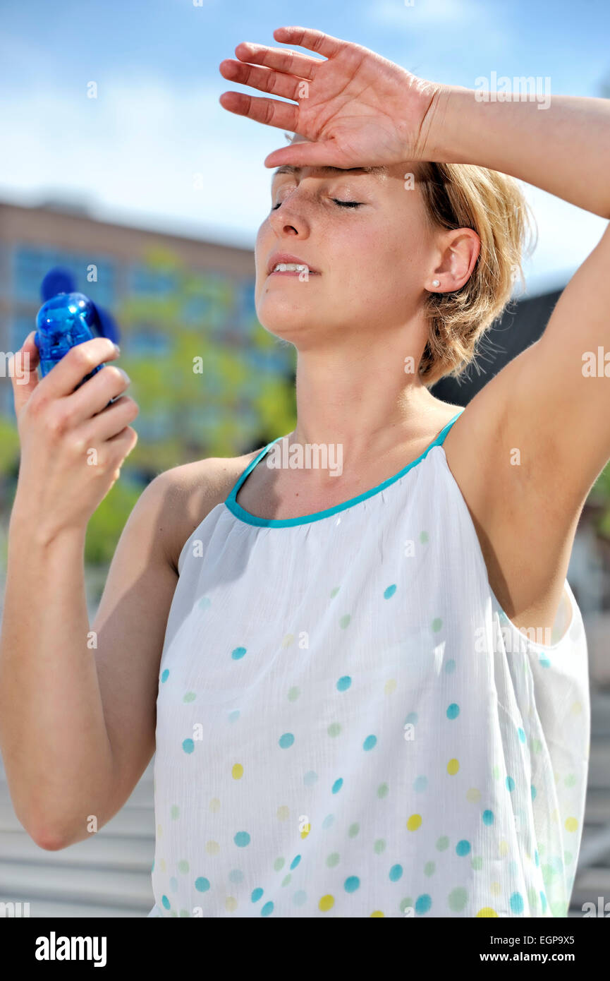 Woman feeling hot and fanning herself hi-res stock photography and ...