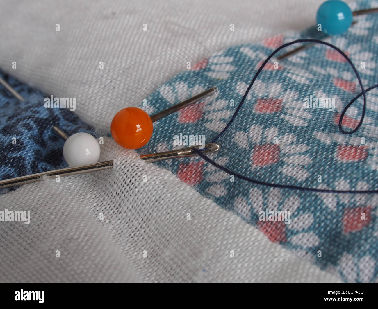 Pins and a threaded sewing needle involved in patchwork Stock Photo - Alamy