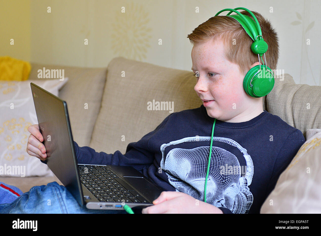 Young boy playing online computer games on laptop. Photo: George ...