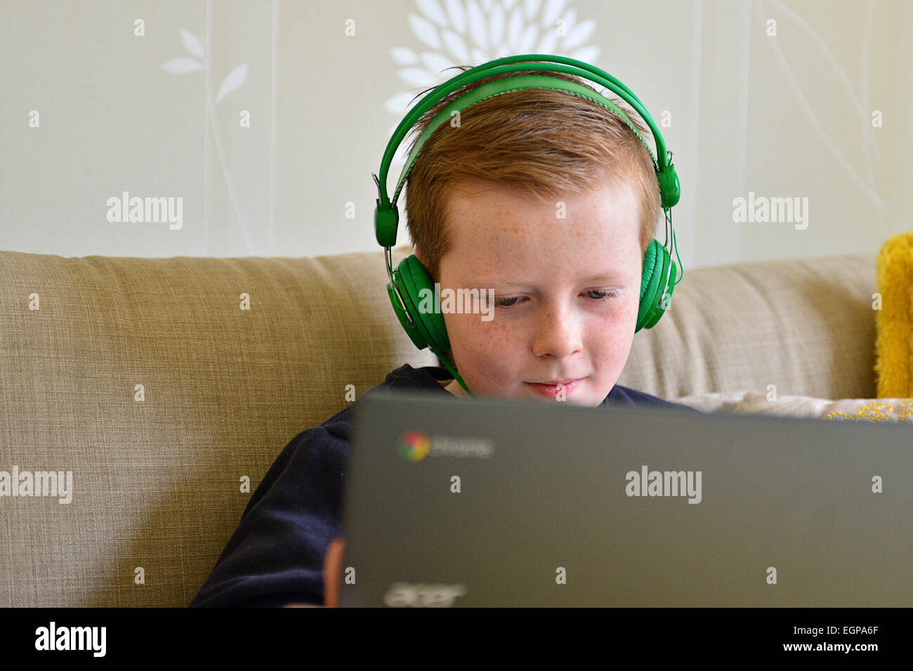 Young boy playing online computer games on laptop. Photo: George ...