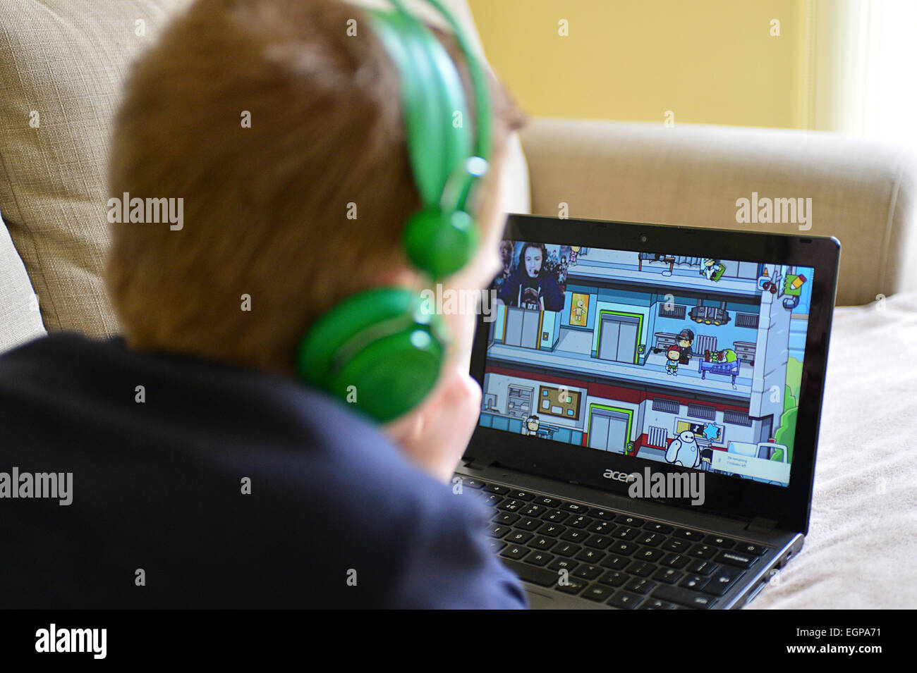 Young boy playing online computer games on laptop. Photo: George ...