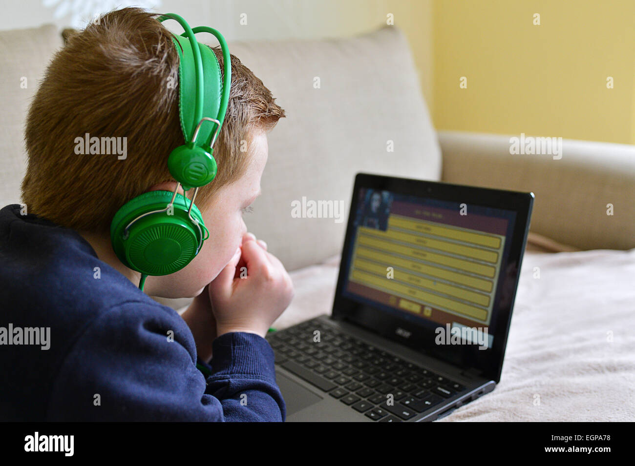 Young boy playing online computer games on laptop. Photo: George ...