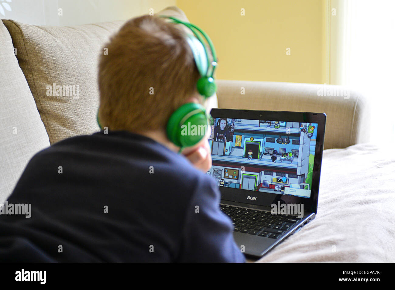 Young boy playing online computer games on laptop. Photo: George ...