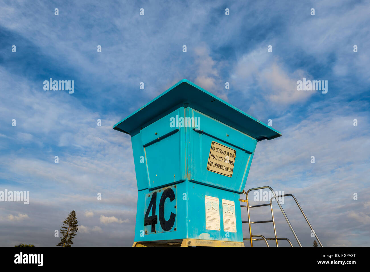View a blue-colored lifeguard tower against a cloudy background ...