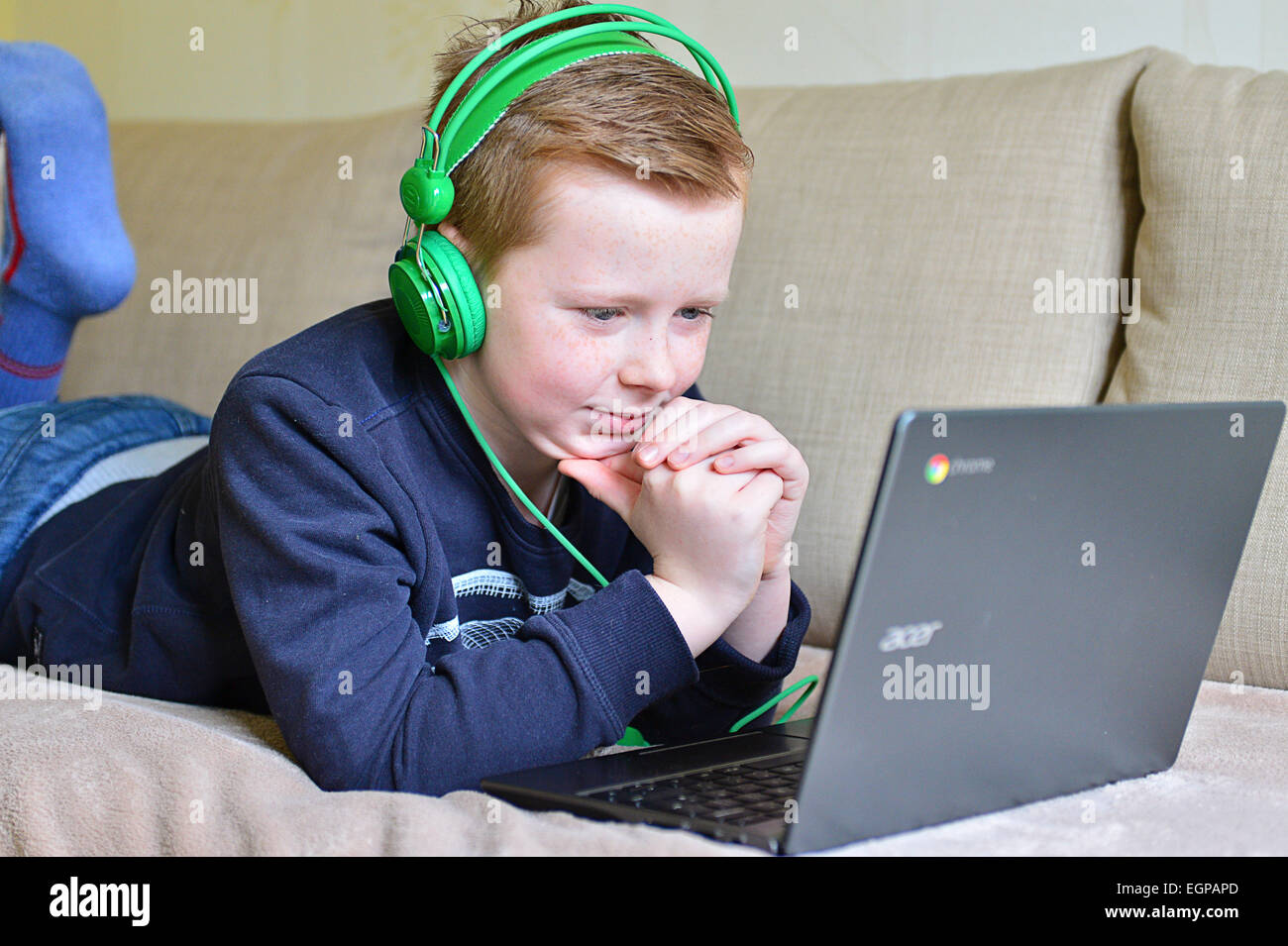 Young boy playing online computer games on laptop. Photo: George ...