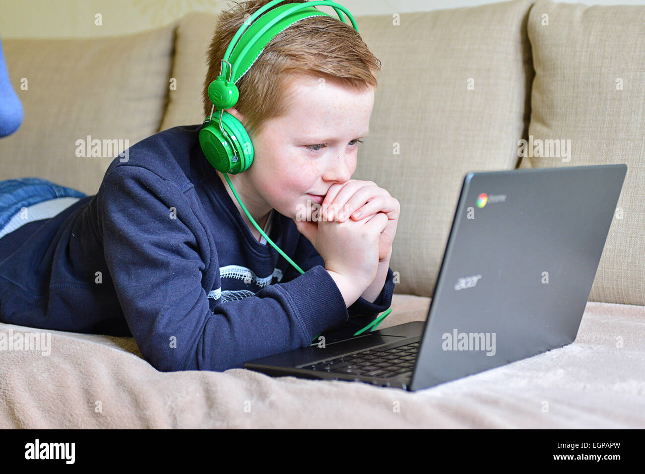 Young boy playing online computer games on laptop. Photo: George ...
