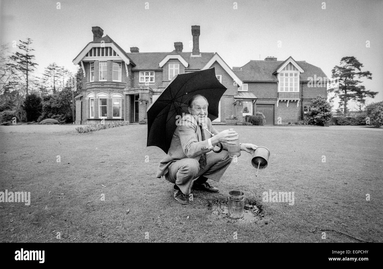 Sir Norman Longley checking the rainfall in his garden in Crawley, West ...
