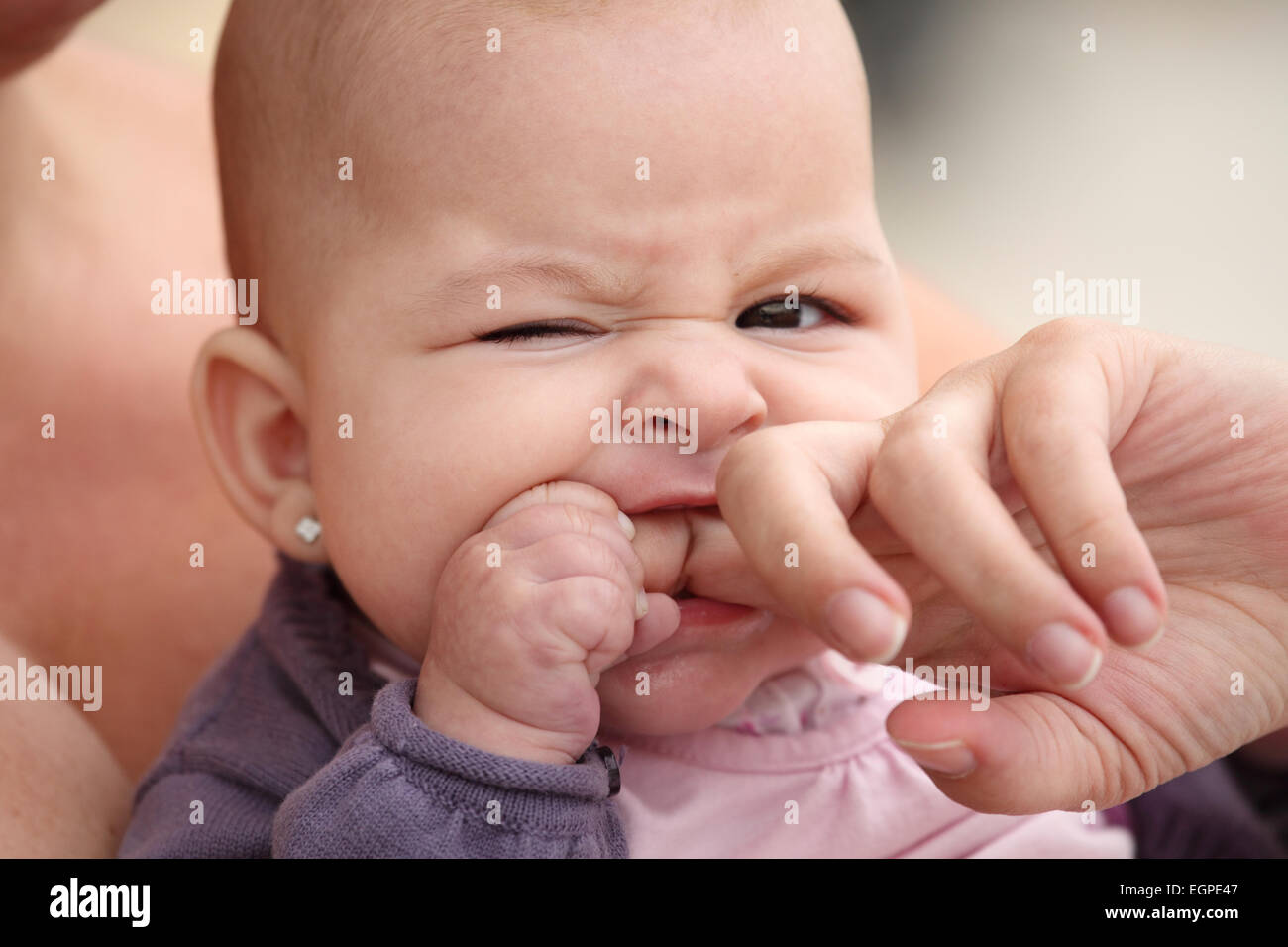 little baby biting her mother finger Stock Photo - Alamy