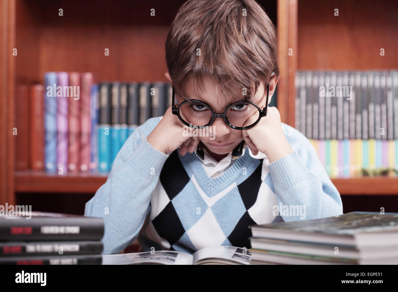 Child studying in the library Stock Photo - Alamy