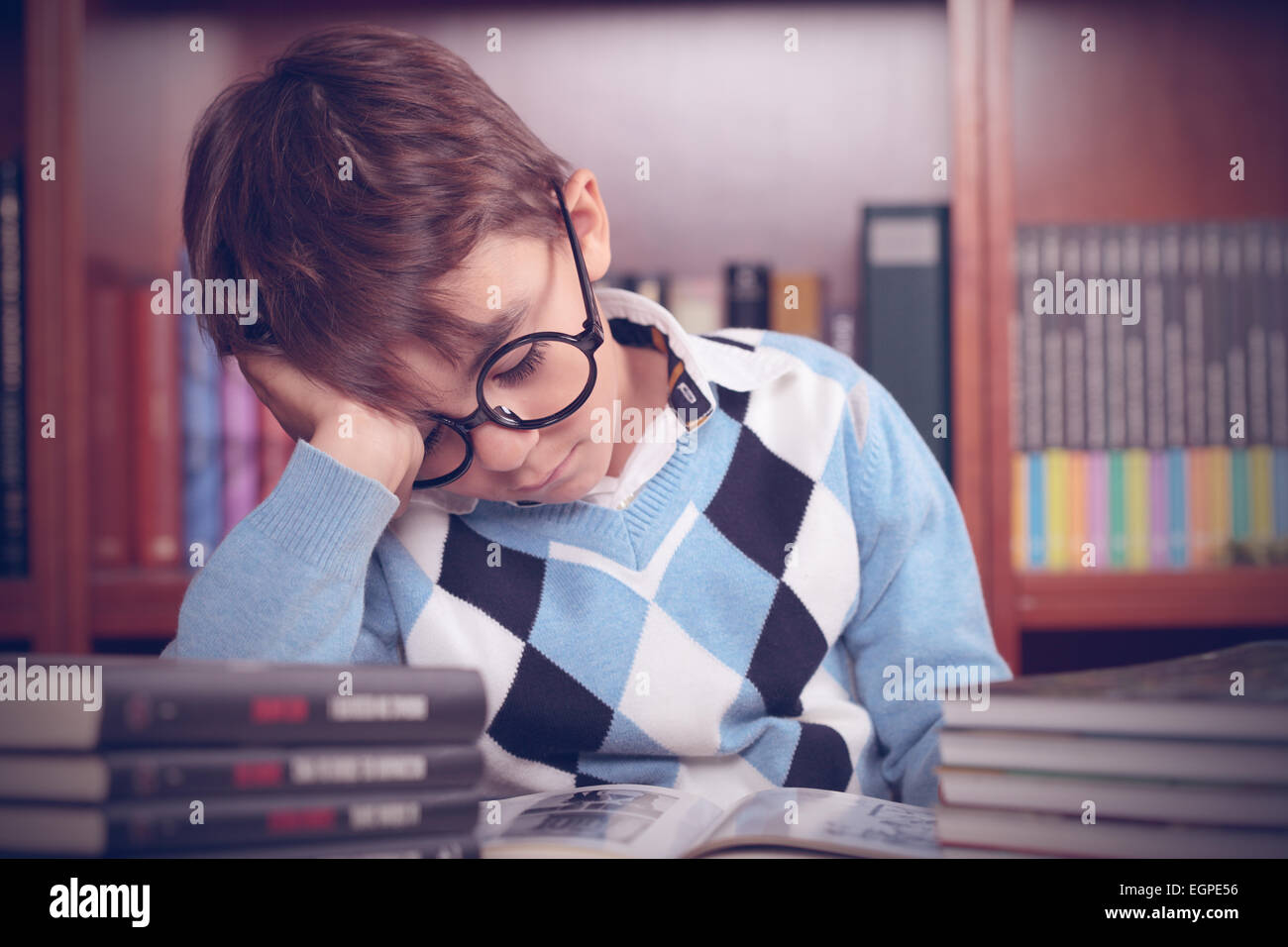 Child studying and bored in the library Stock Photo - Alamy