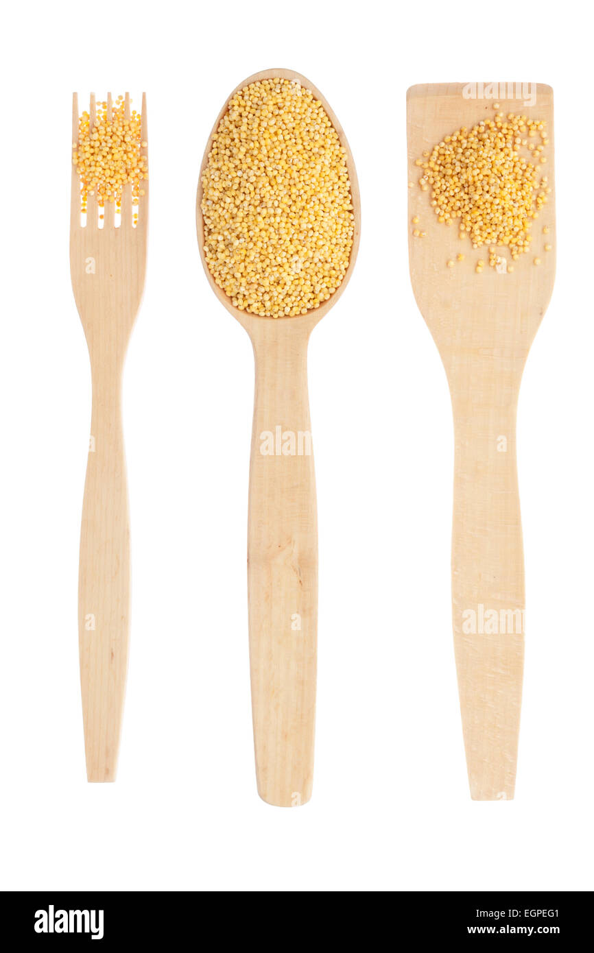 Wooden spoon, fork, paddle with millet, isolated on white background ...