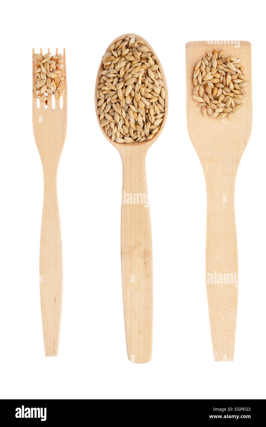 Wooden spoon, fork, paddle with barley, isolated on white background ...